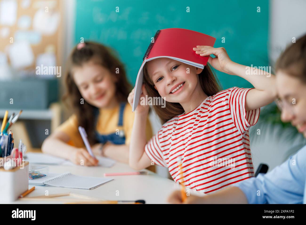 Happy kids at school. Children are learning in the class Stock Photo ...