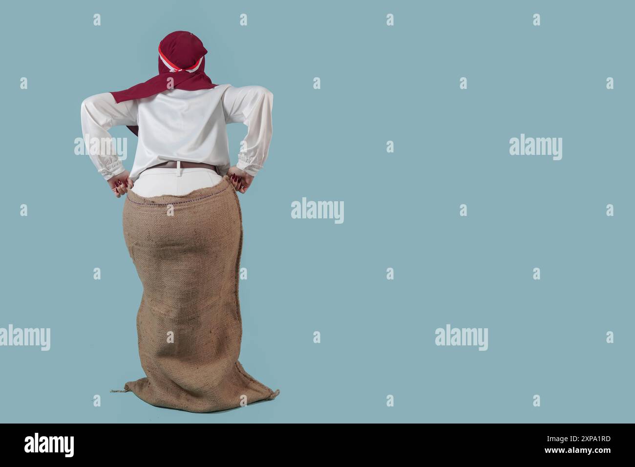 Back portrait of Indonesian woman wearing a hijab and gunny sack to ...