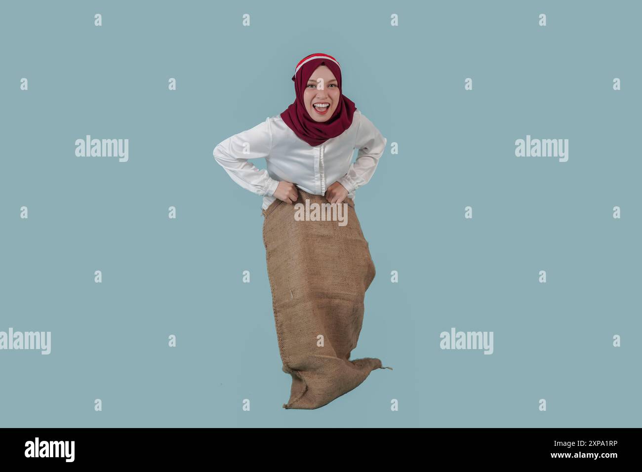 Excited Indonesian woman wearing a hijab and gunny sack to join ...