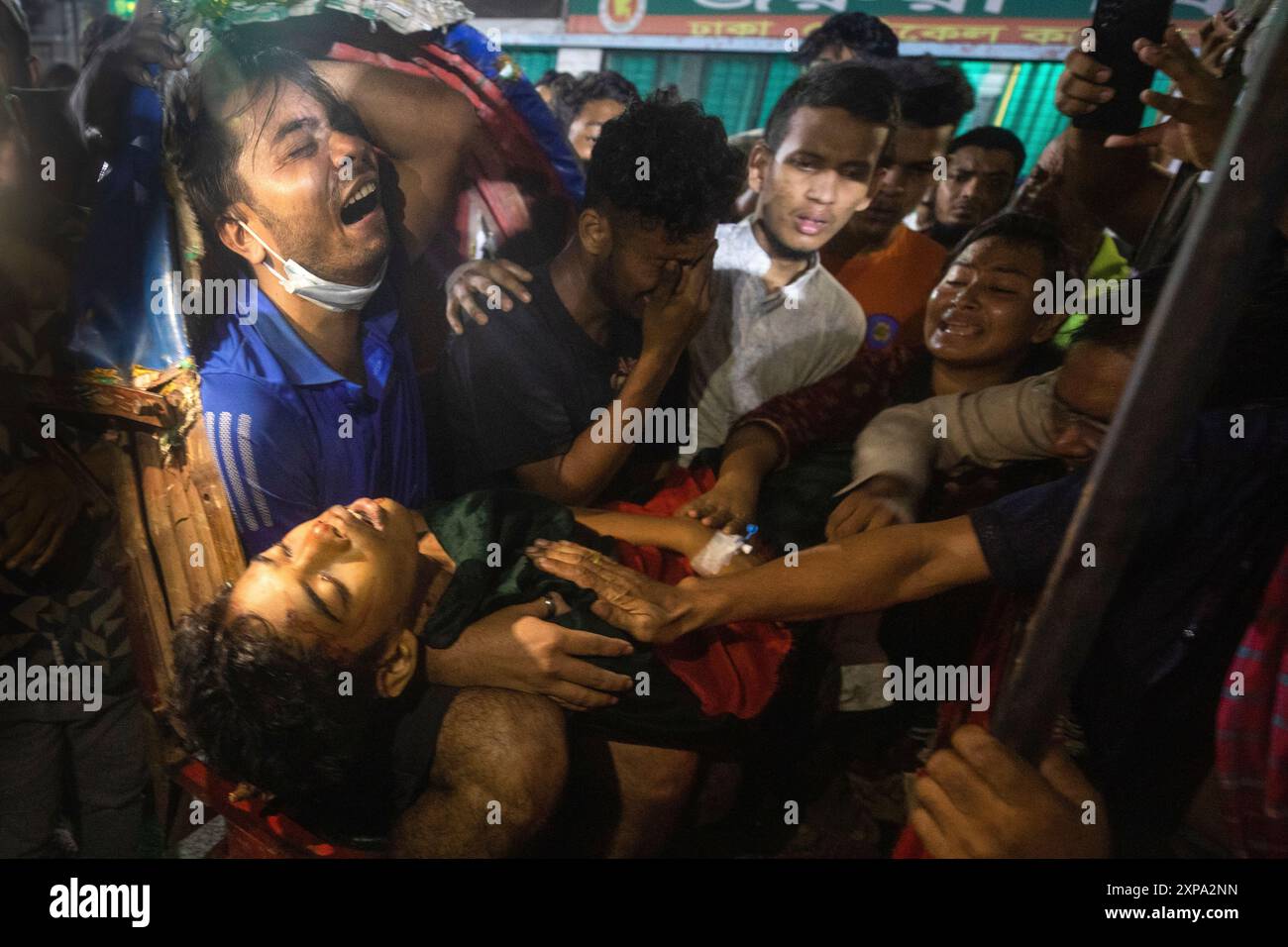 People cry as the dead body of a man, who was killed during the anti ...