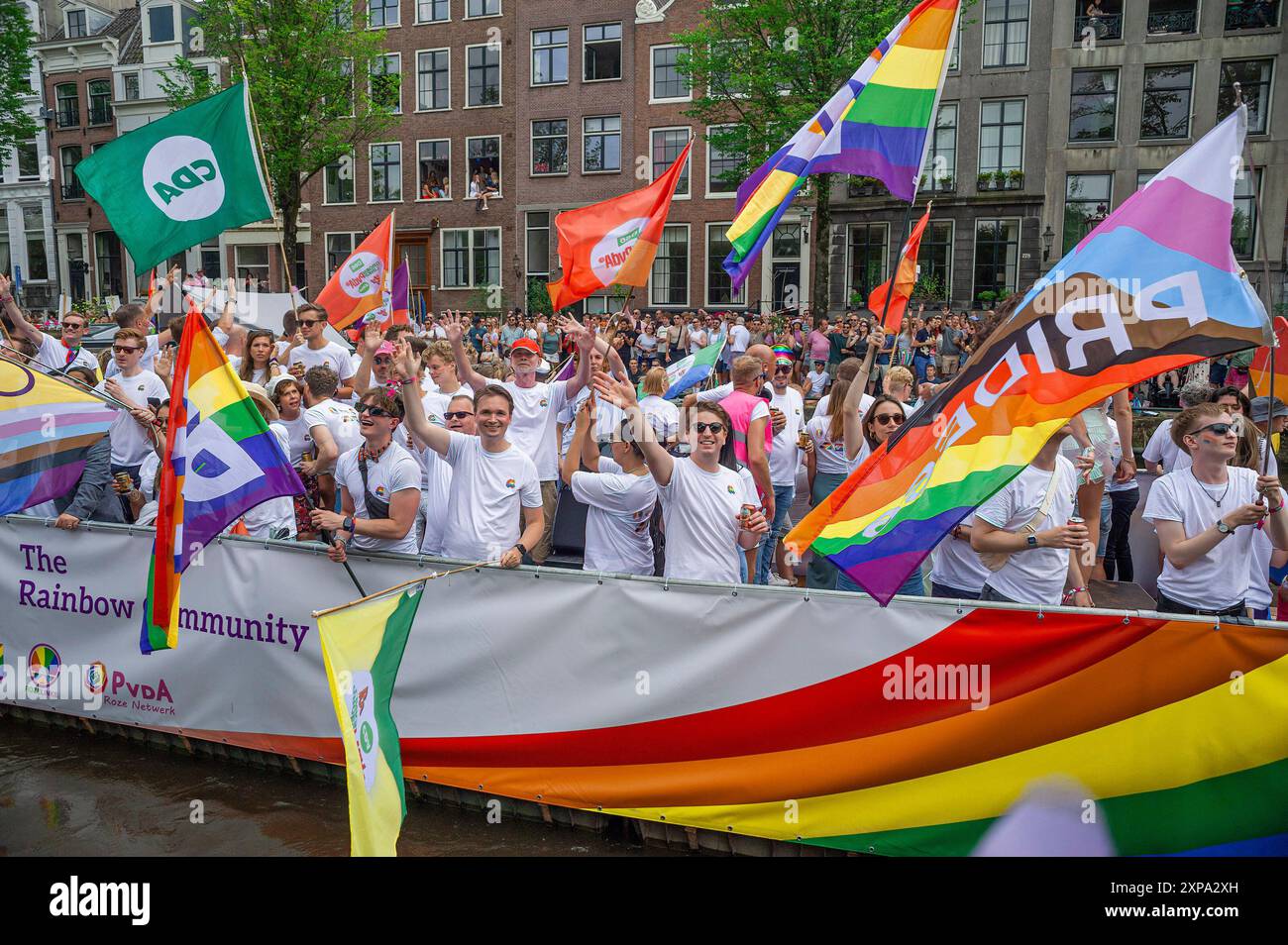 Decorative boats with participants in colorful costumes sail along a ...