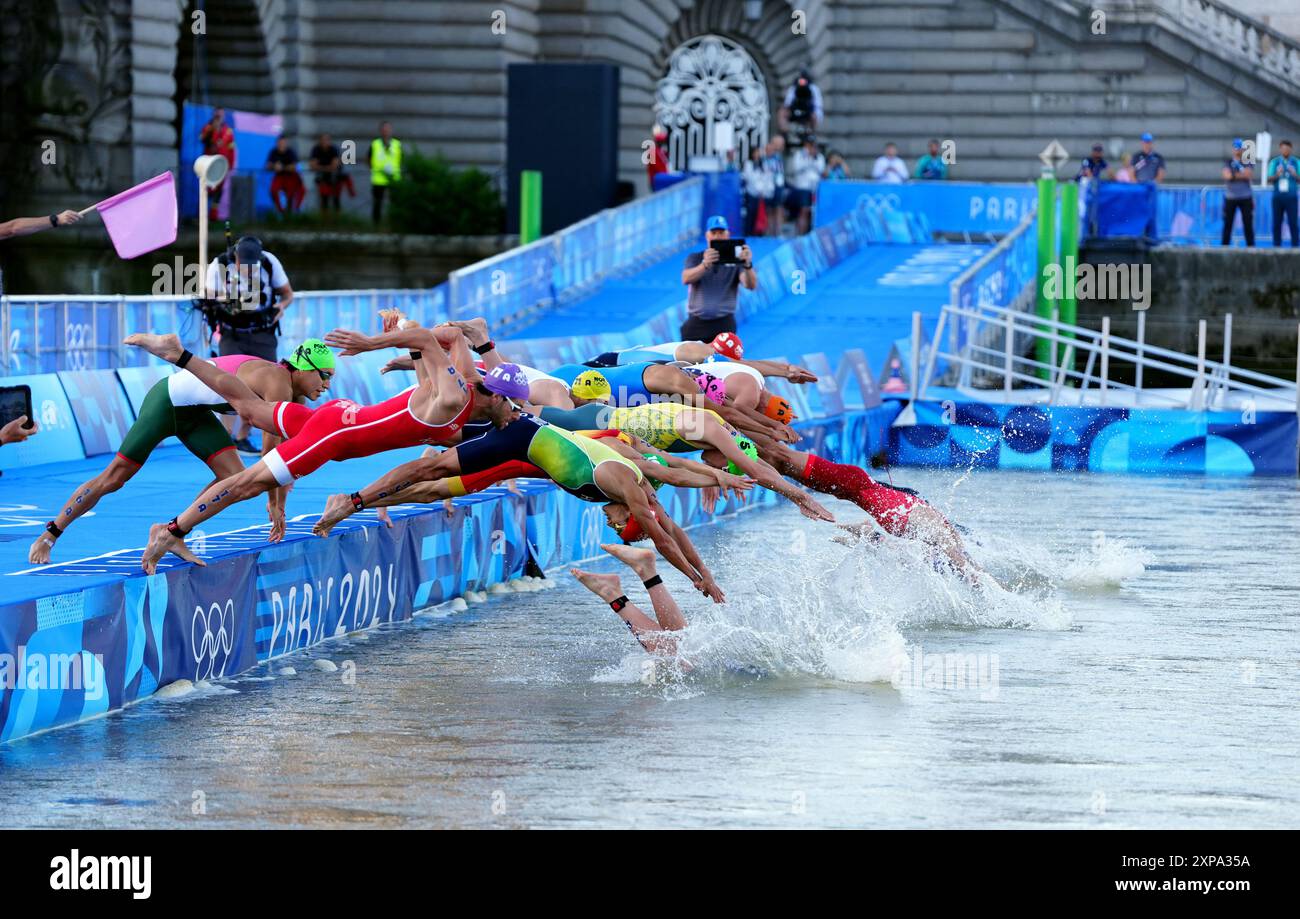 Athletes enter the River Seine at the start of the Mixed Relay ...