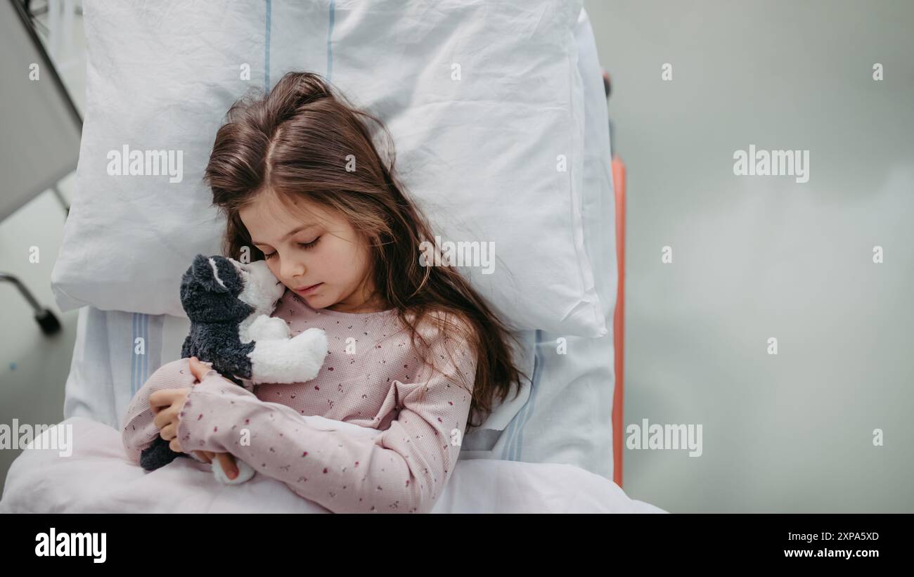 Little girl patient lying in hospital bed. Children in intensive care ...
