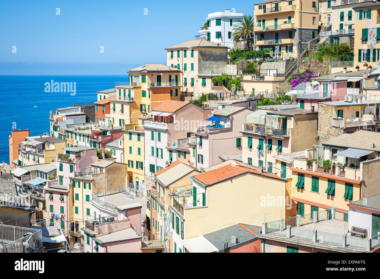 Classic light colored italian houses on a cliff in the village of ...