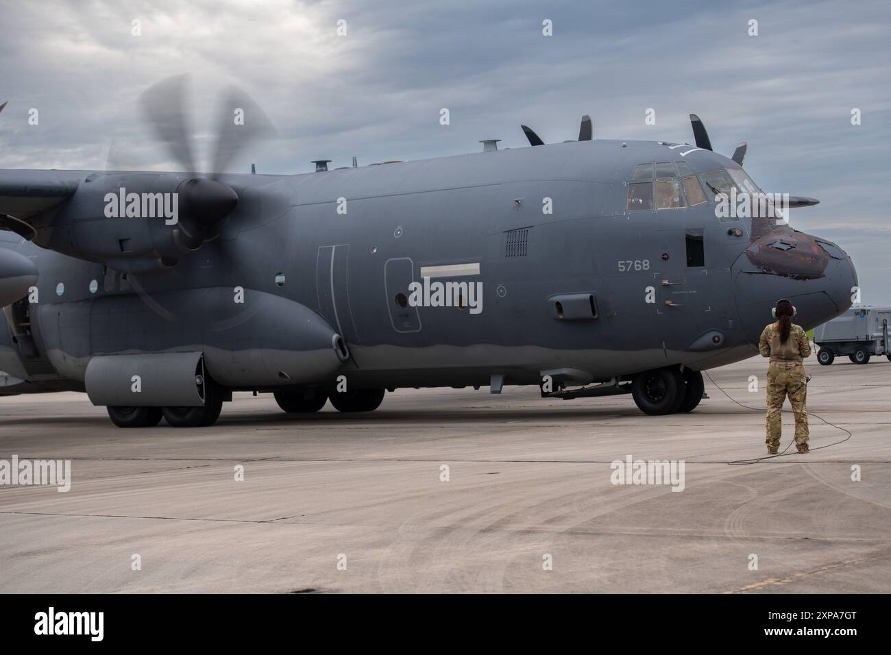 A U.S. Air Force crew chief assigned to the 71st Rescue Generation Squadron assists with storm ...
