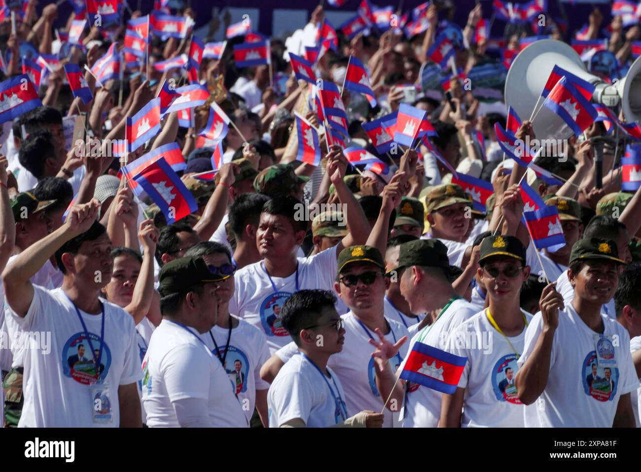 Cambodian civil servants wave their national flags during a ...