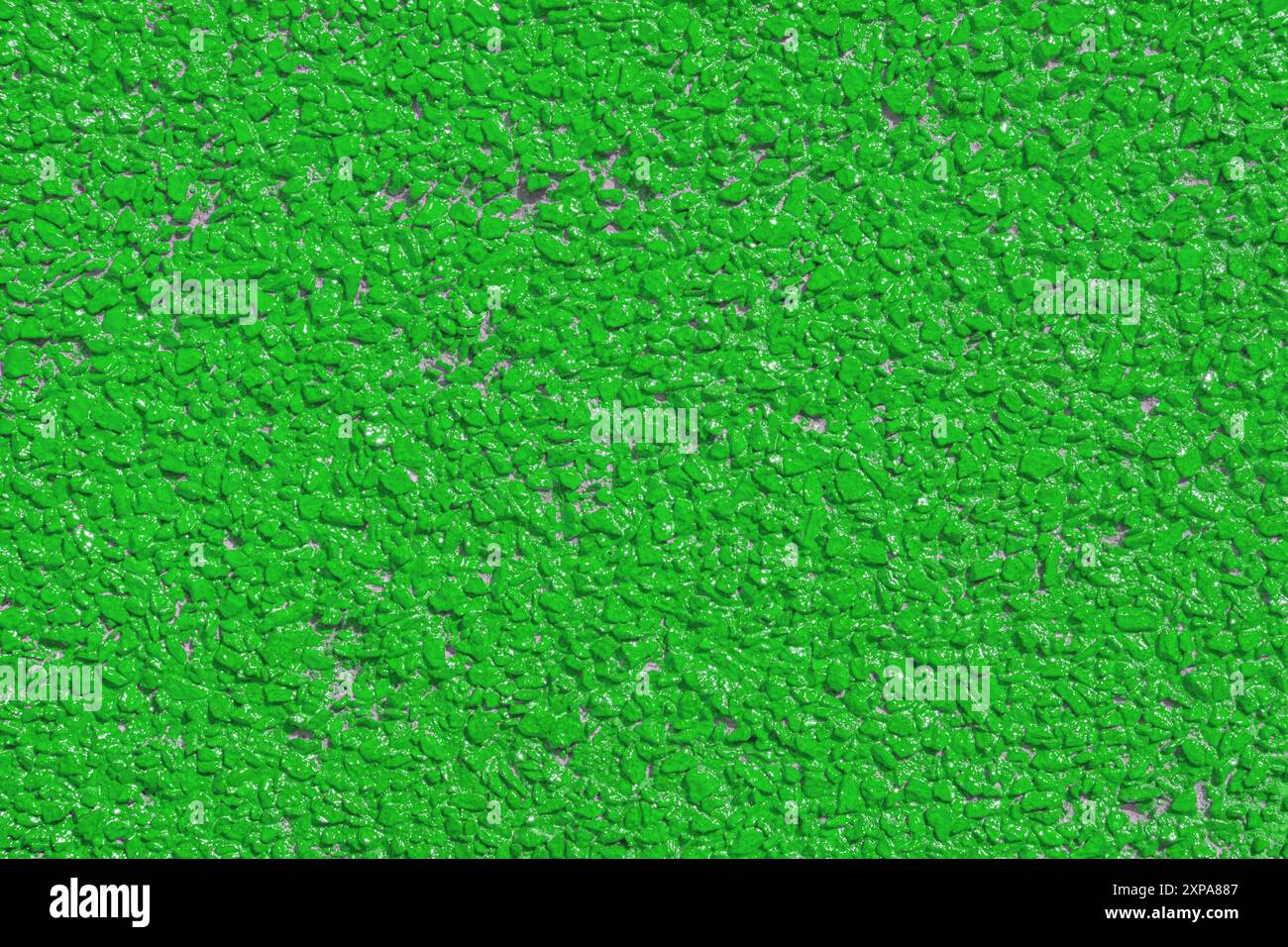 Close-up texture of green rubberized surface with small granules ...