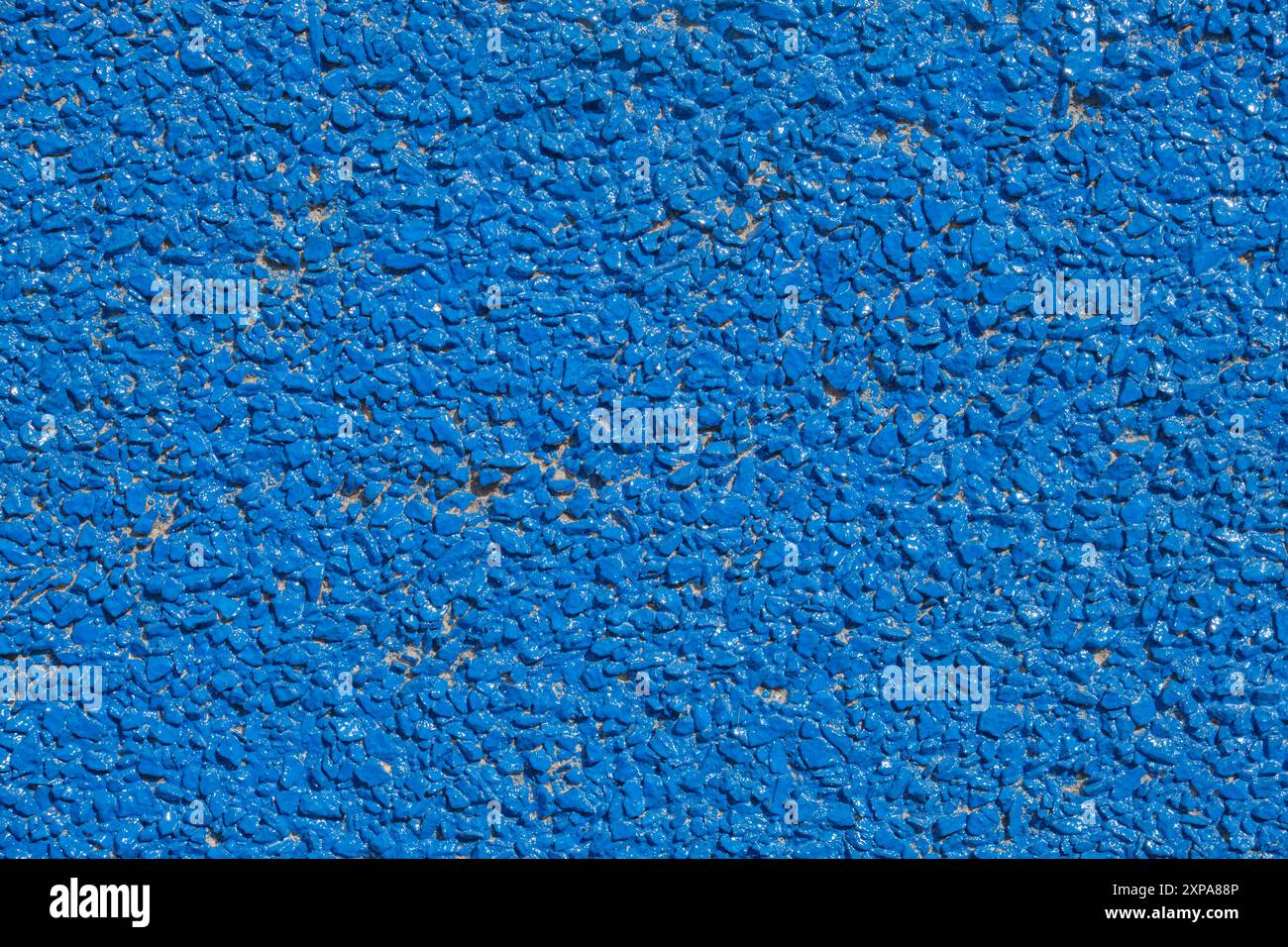 Close-up texture of blue rubberized surface with small granules ...
