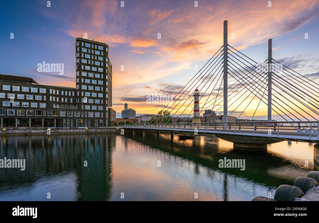 A beautiful bridge spans a body of water in Malmo city at sunset Stock ...