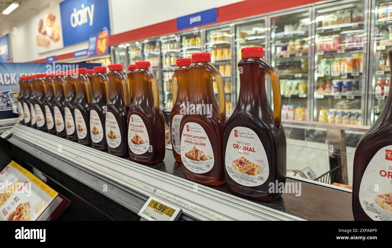 Display a long table syrup on sale in a superstore Stock Photo - Alamy