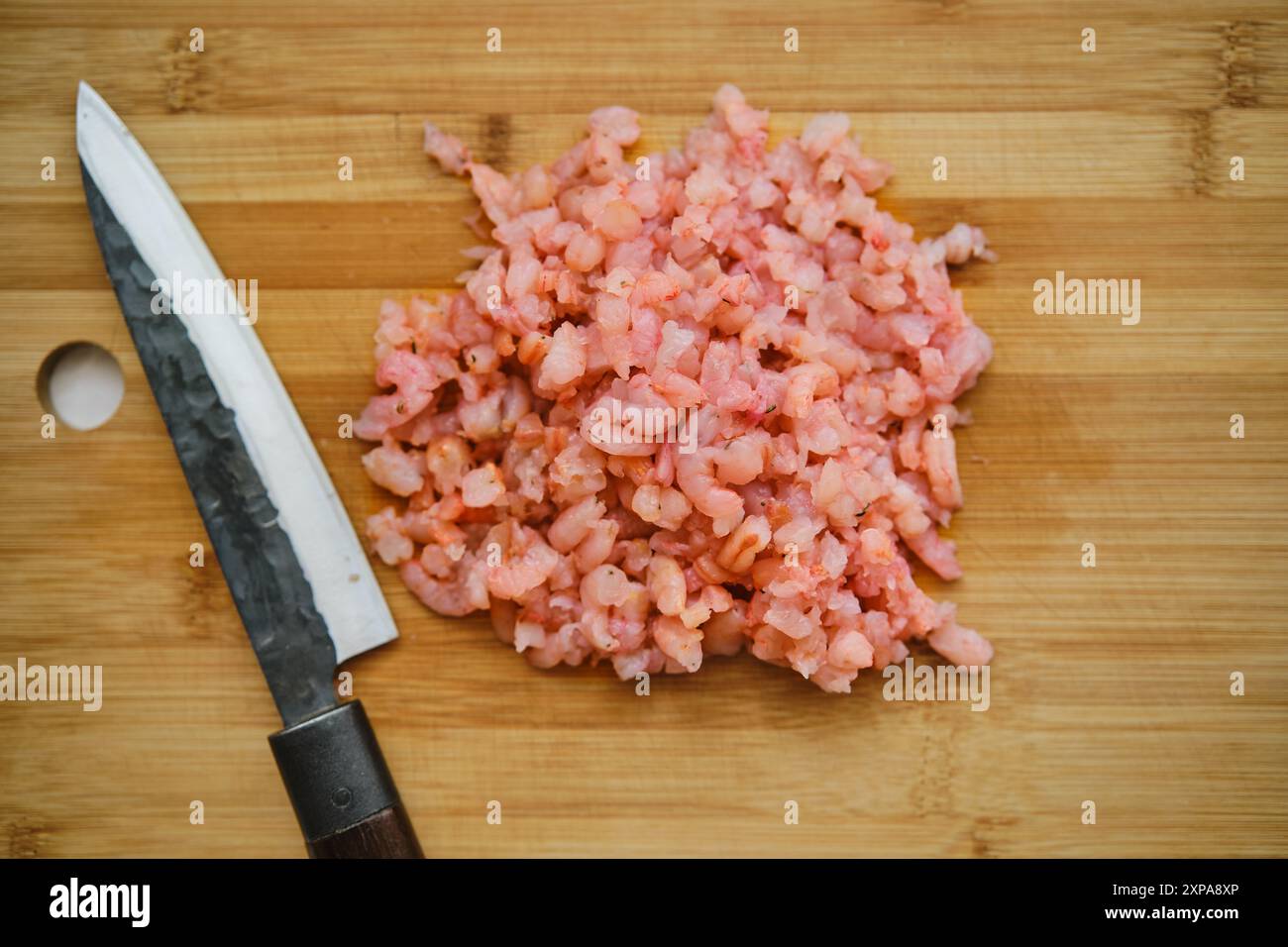 Overhead view of roughly chopped shrimps on cutting board Stock Photo ...