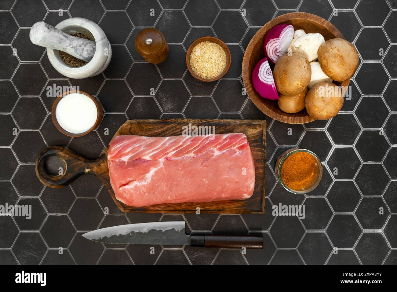 Overhead view of raw pork fillet, fresh champignons and spice ready for ...