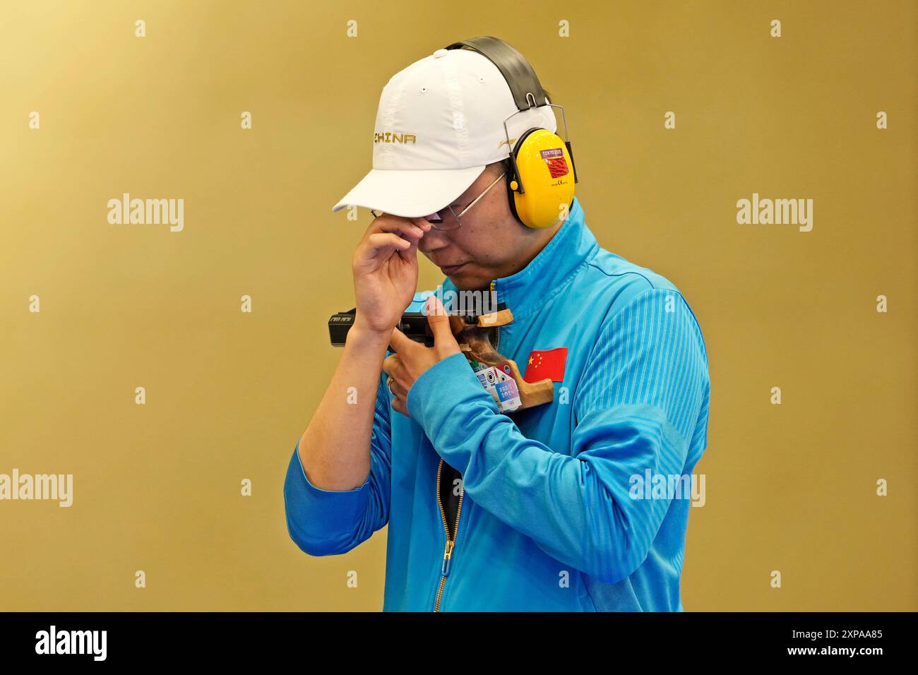 China's Li Yuehong reacts as he competes in the 25m rapid fire pistol ...