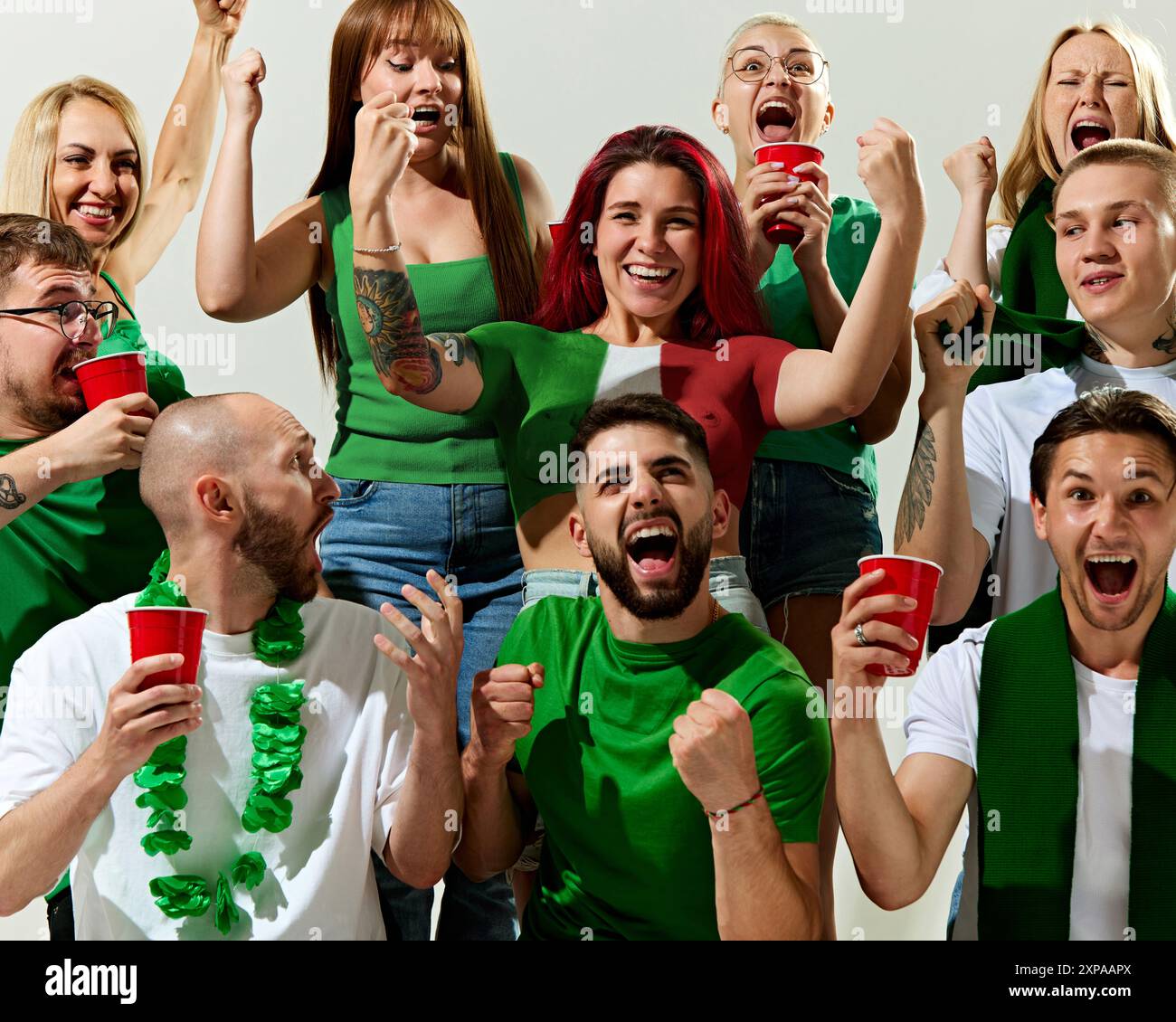 Goal. Super emotional young people, men and women in matching green ...