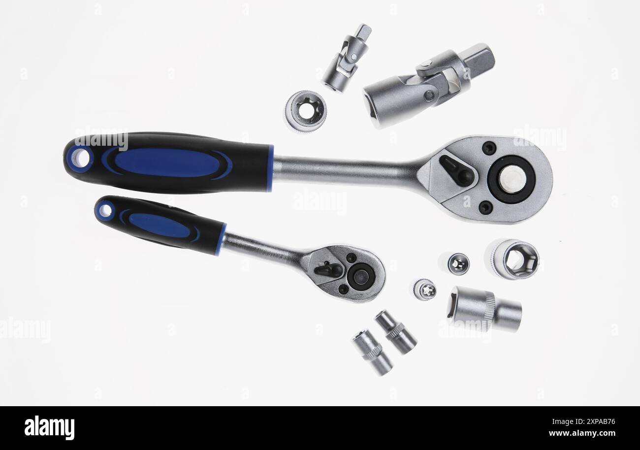 Two torque wrenches and nuts on white, flat lay. Auto mechanic tools ...