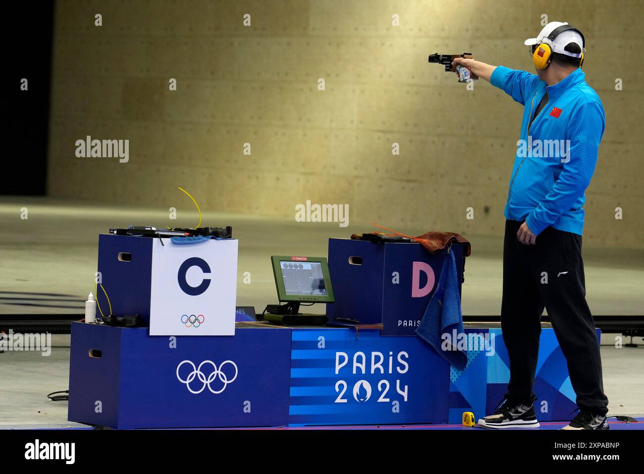 China's Li Yuehong competes in the 25m rapid fire pistol men's final at ...