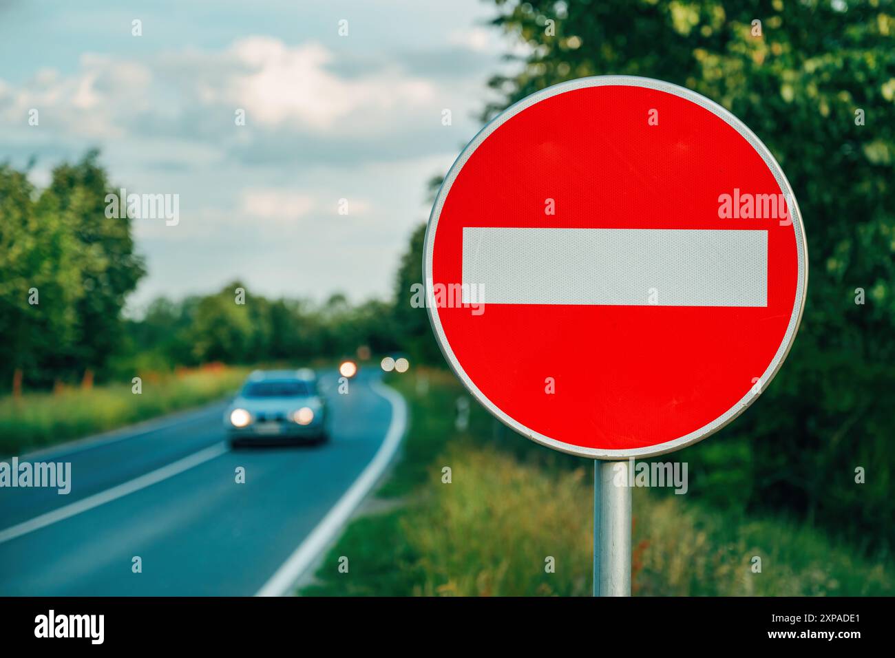 No Entry traffic sign by the european road with cars driving along the ...