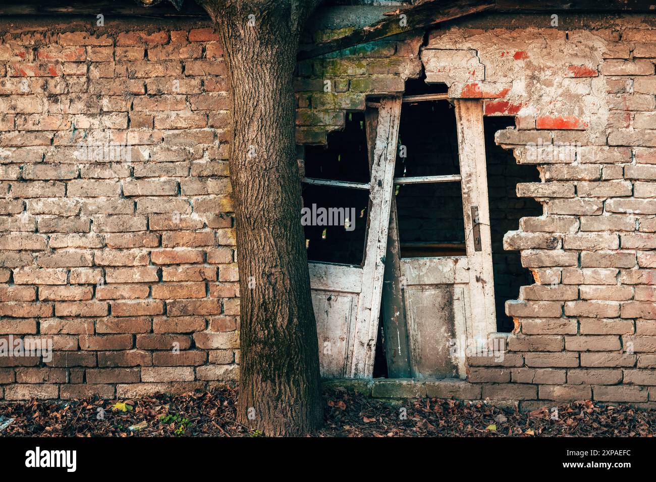 Old ruined house with damaged brick wall and broken doors ready for ...