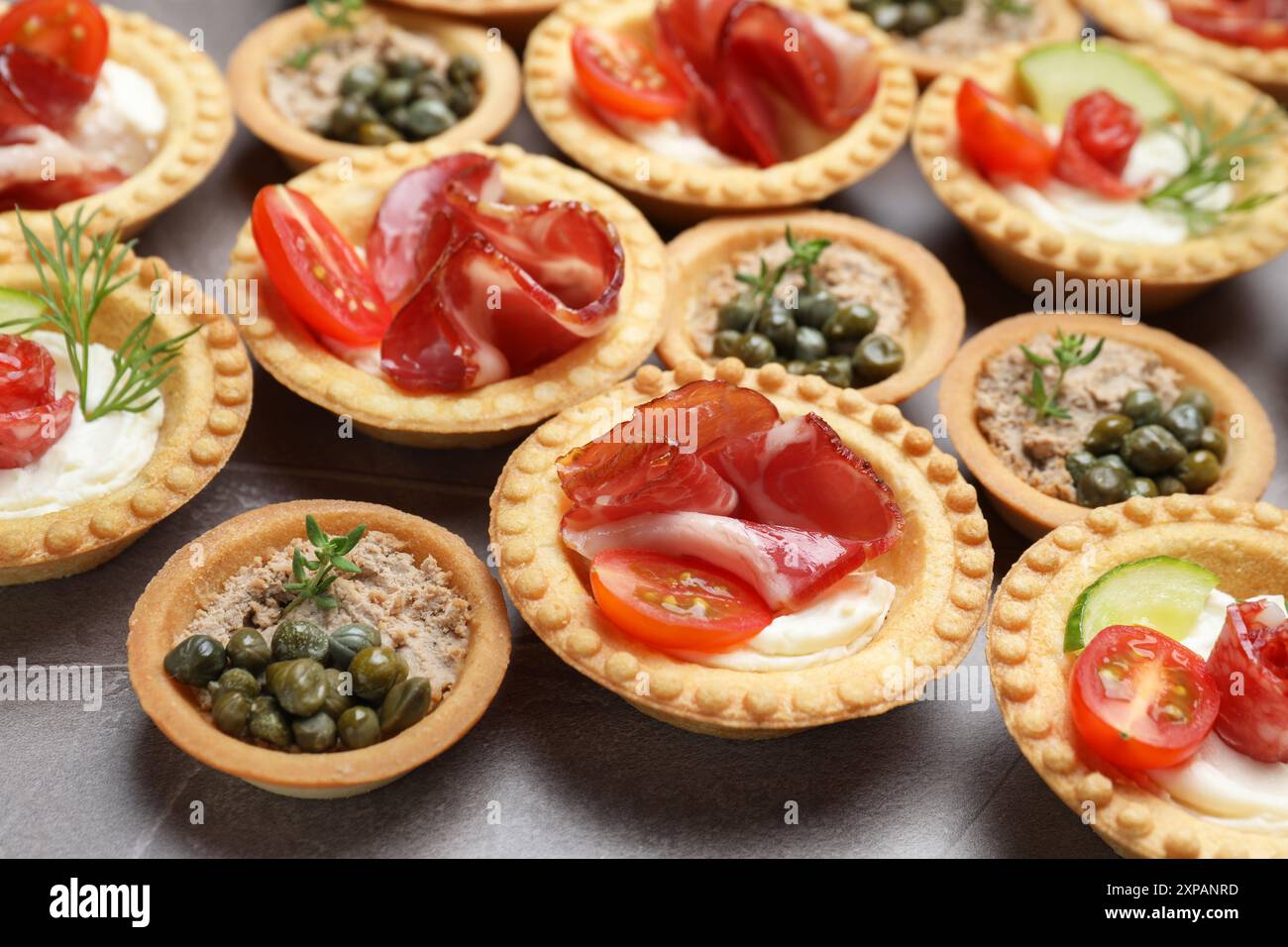 Different delicious canapes on grey table, closeup Stock Photo - Alamy