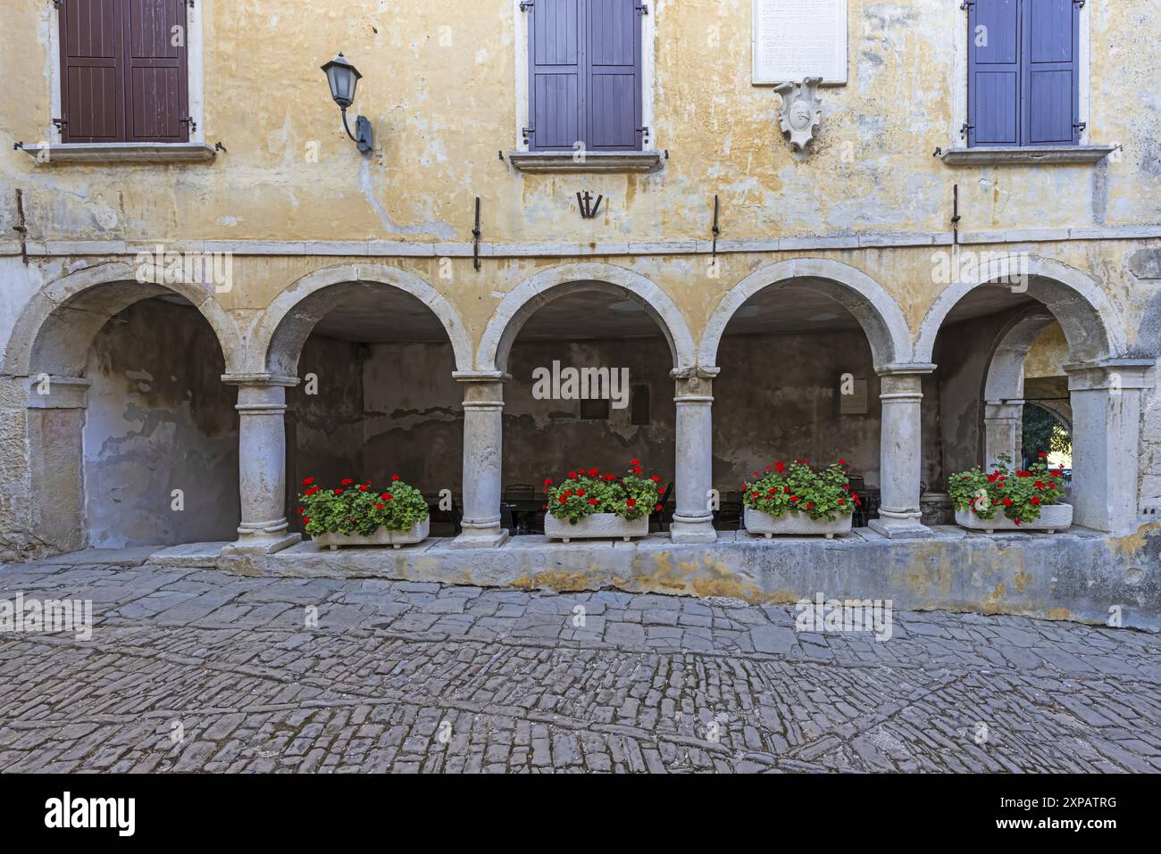 A picturesque stone plaza featuring decorative flower arrangements and ...