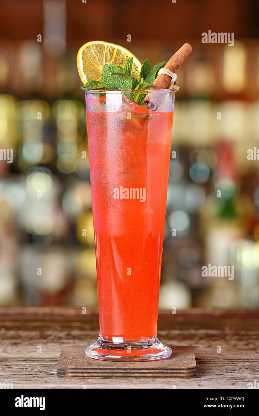 Alcoholic cocktail fruit sling is on the bar, photo for the menu, space ...