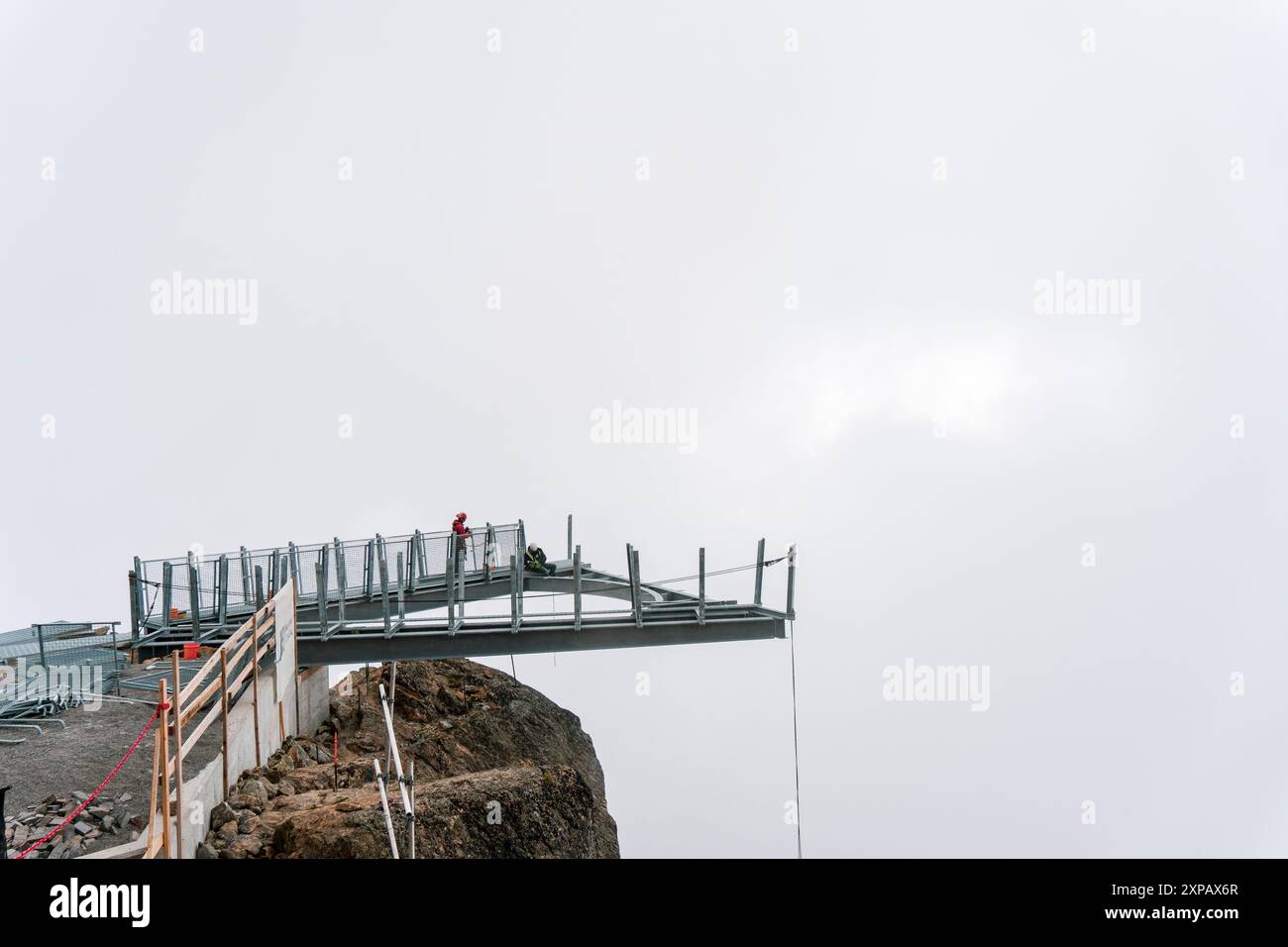 Construction workers working on skywalk bridge, WhistlerÂ BlackcombÂ ...