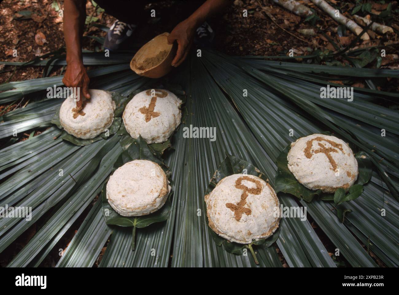 A man prepares bread during a rain ceremony in Yodzonot, Yucatan ...