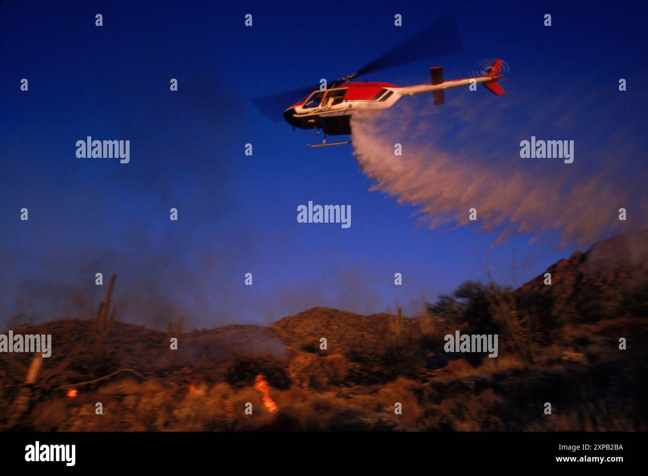 Desert fire fought with a helicopter Stock Photo - Alamy