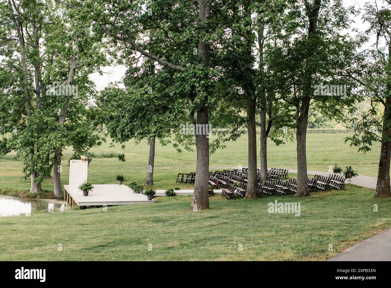 Outdoor wedding ceremony setup in a wooded area with a platform Stock ...