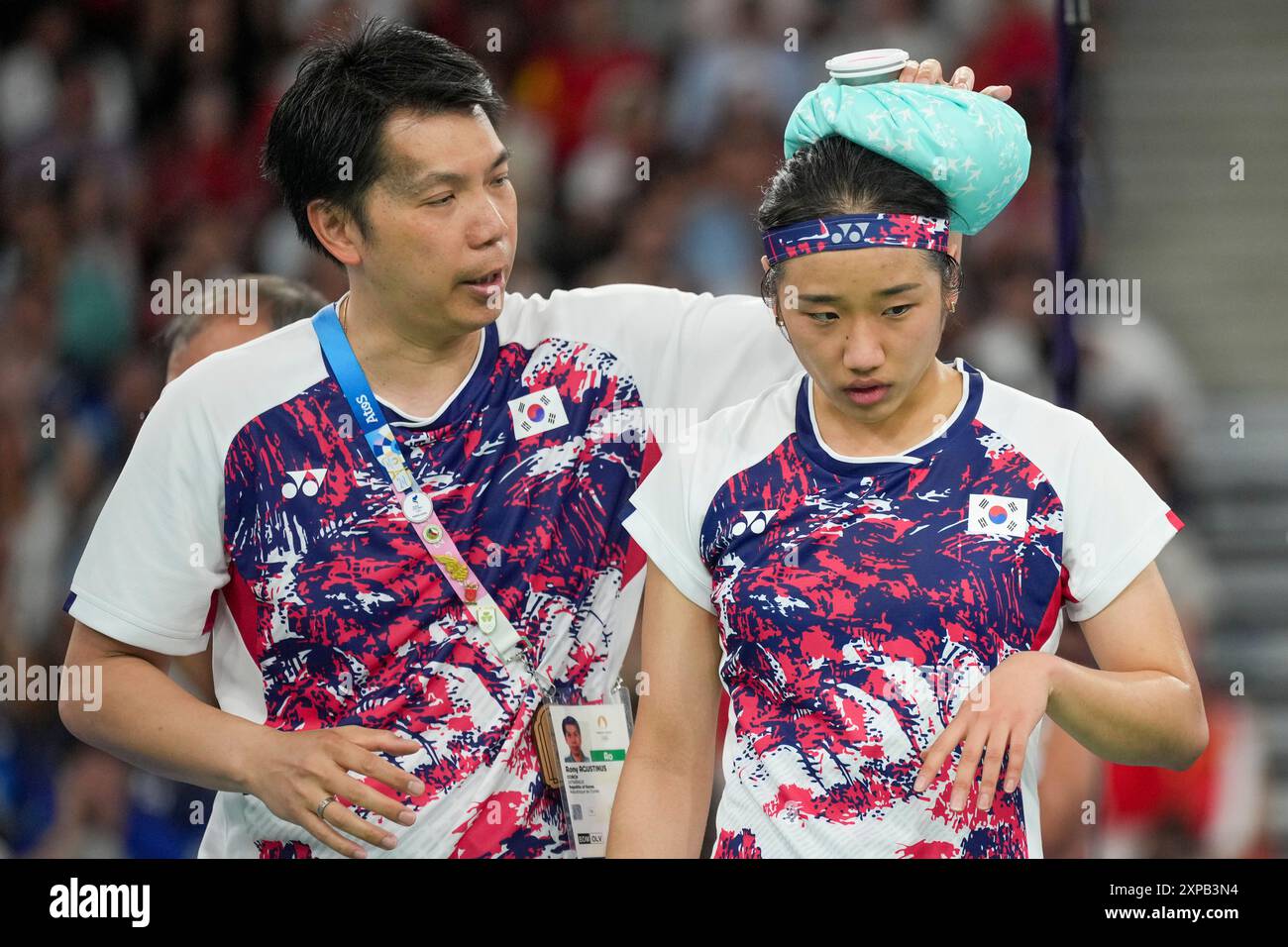 South Korea's coach Rony Agustinus, left, holds an ice bag on South ...