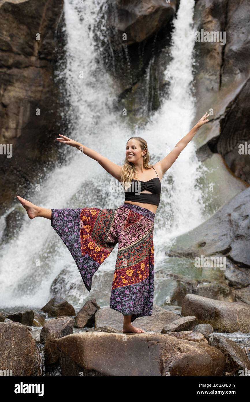 Woman poses in front of waterfall Stock Photo - Alamy