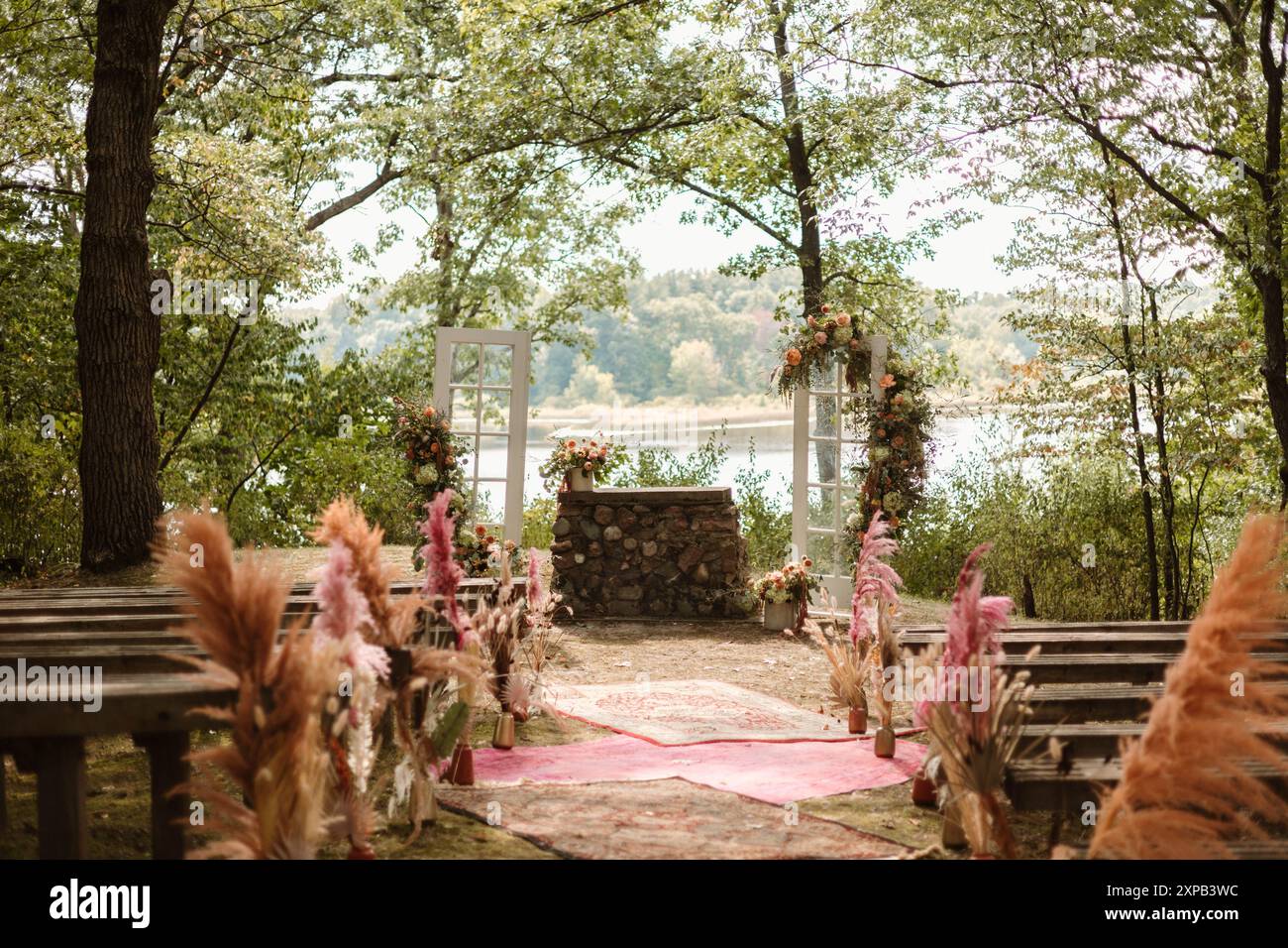 Outdoor fall, boho wedding ceremony setup by a lake Stock Photo - Alamy