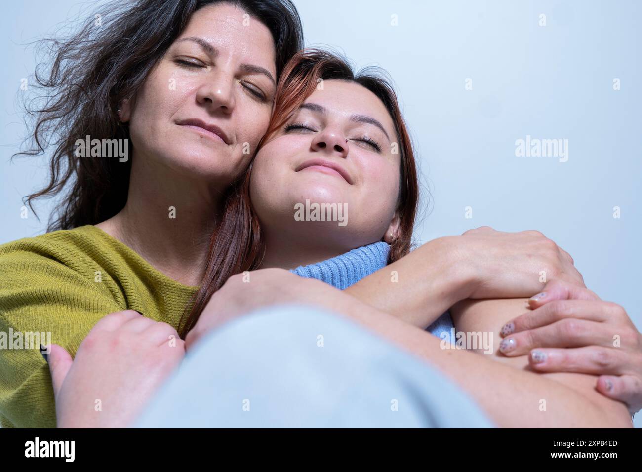 Mom and daughter resting together in a warm embrace Stock Photo - Alamy