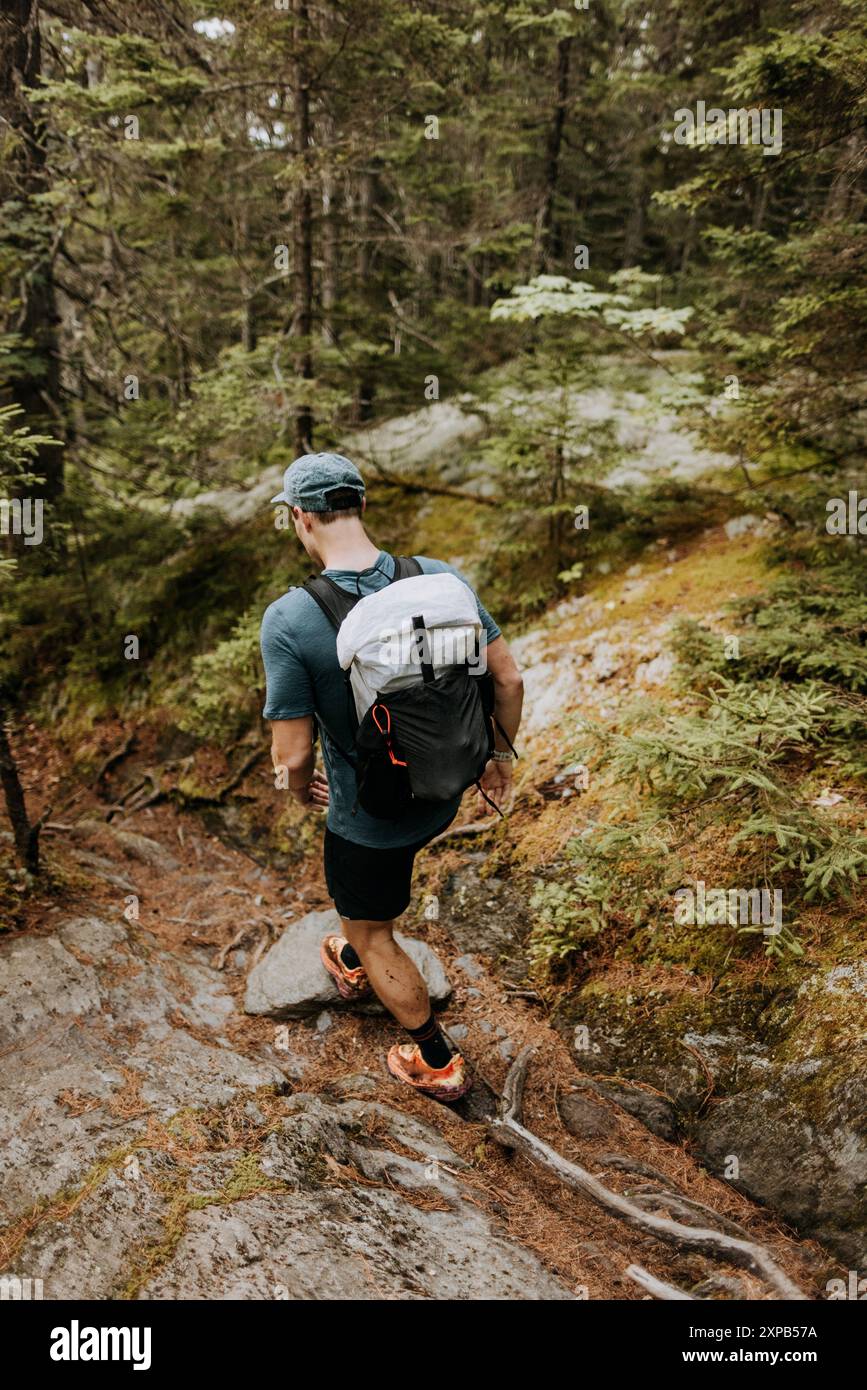 Male hikes along rocks and roots of Appalachian Trail in Maine Stock ...