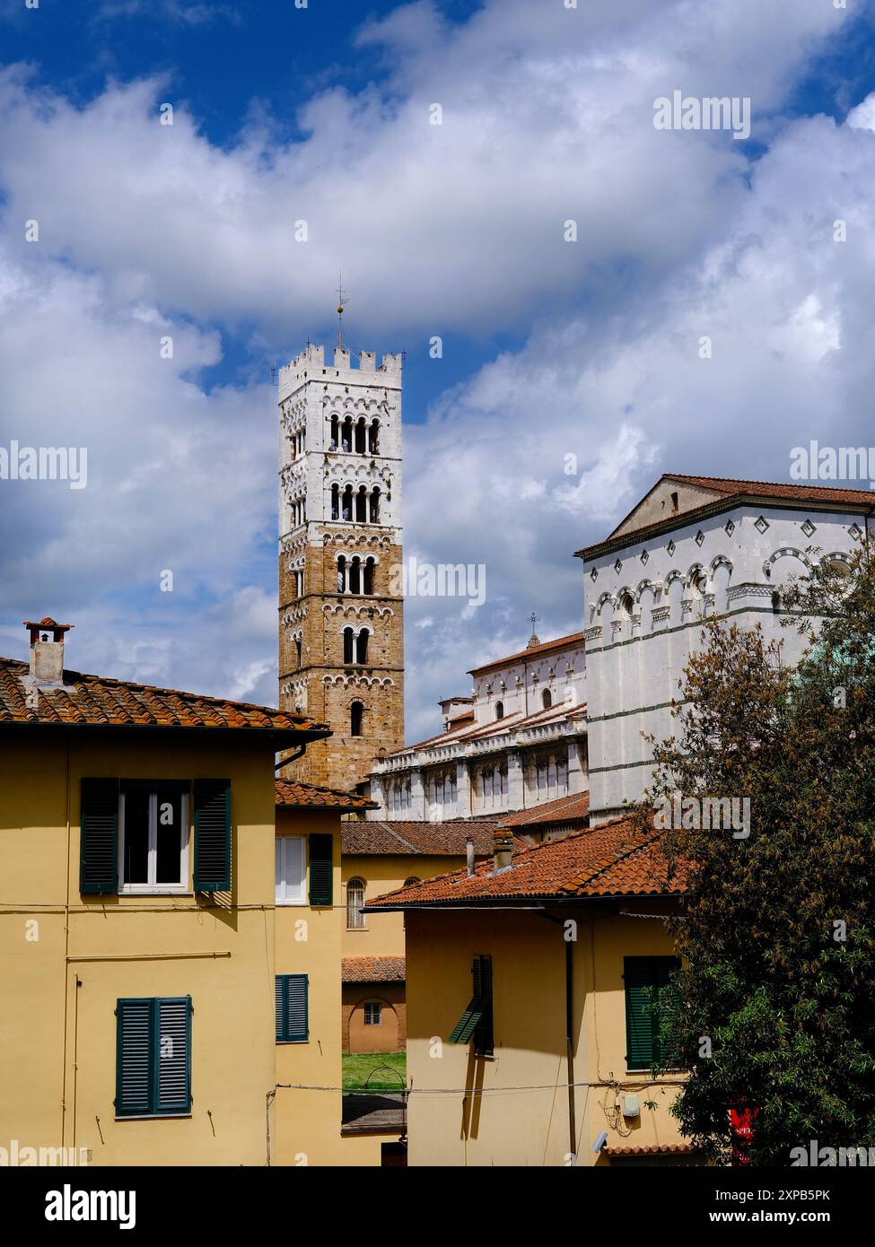 Lucca Cathedral medieval bell tower among clouds, erected in the 13th ...