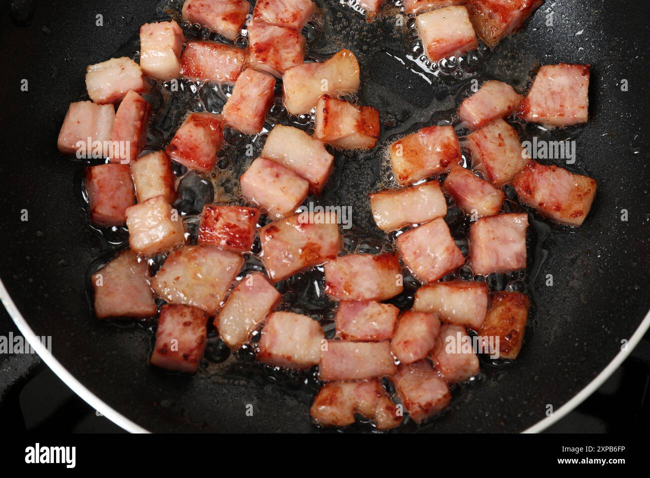 Pieces of bacon frying in pan, top view Stock Photo - Alamy
