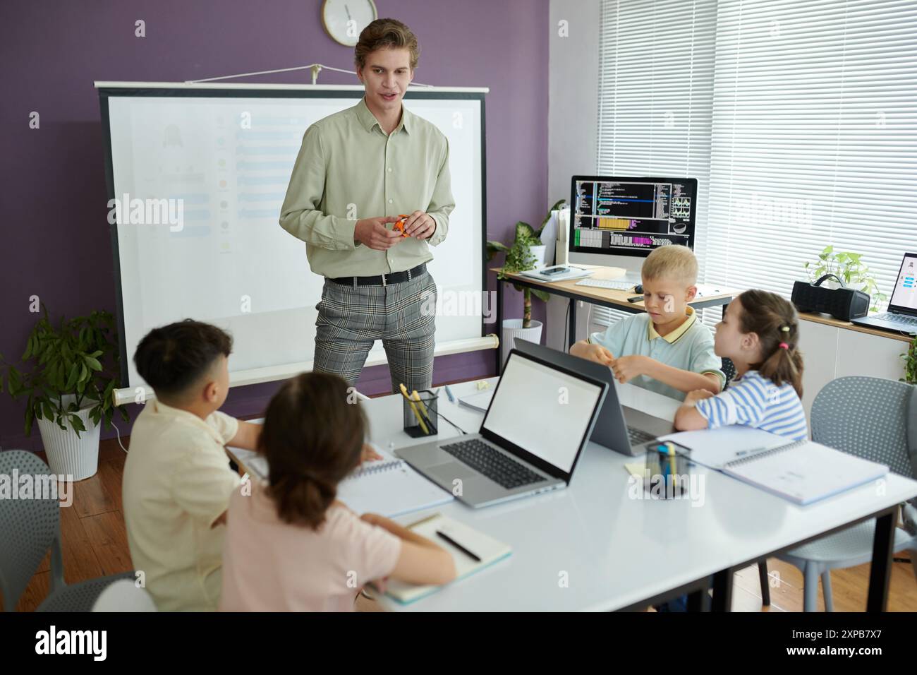 Teacher Engaging Students in Modern Classroom Setting Stock Photo - Alamy