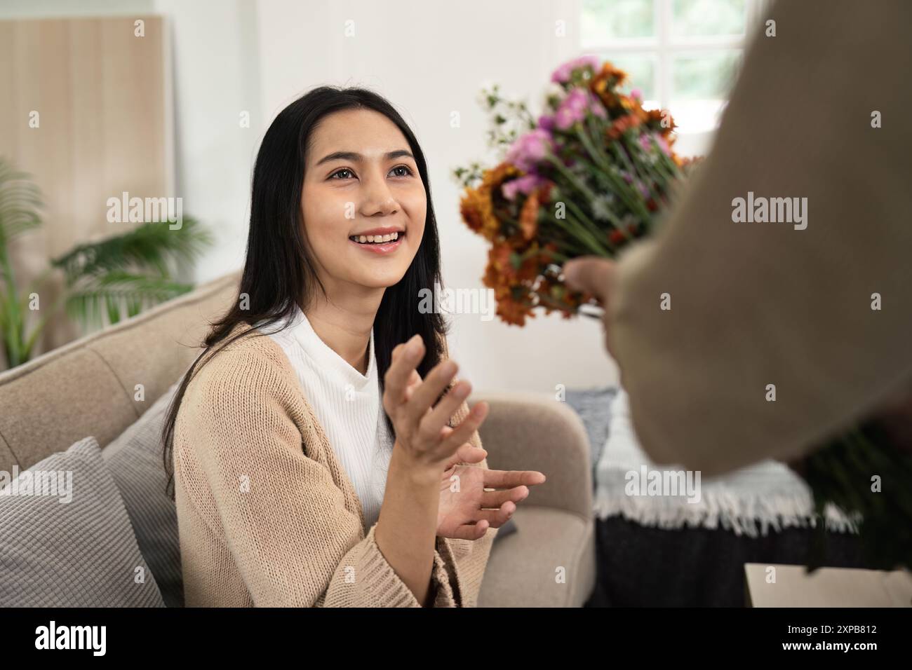 Happy Couple Sharing a Tender Moment with Flowers in a Cozy Modern ...