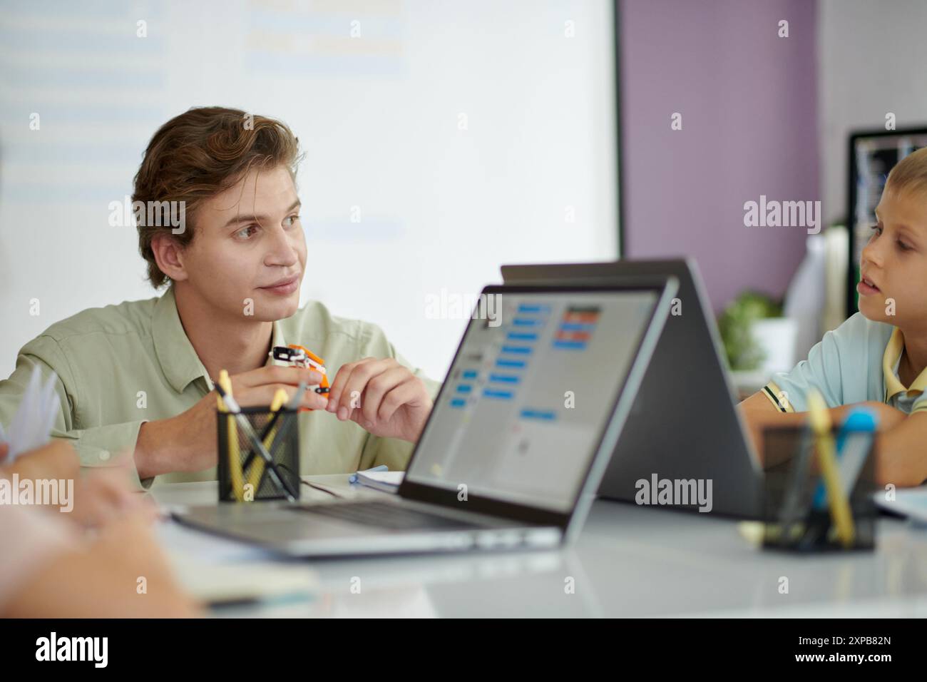 Engaging In Group Discussion Around Conference Table Stock Photo - Alamy