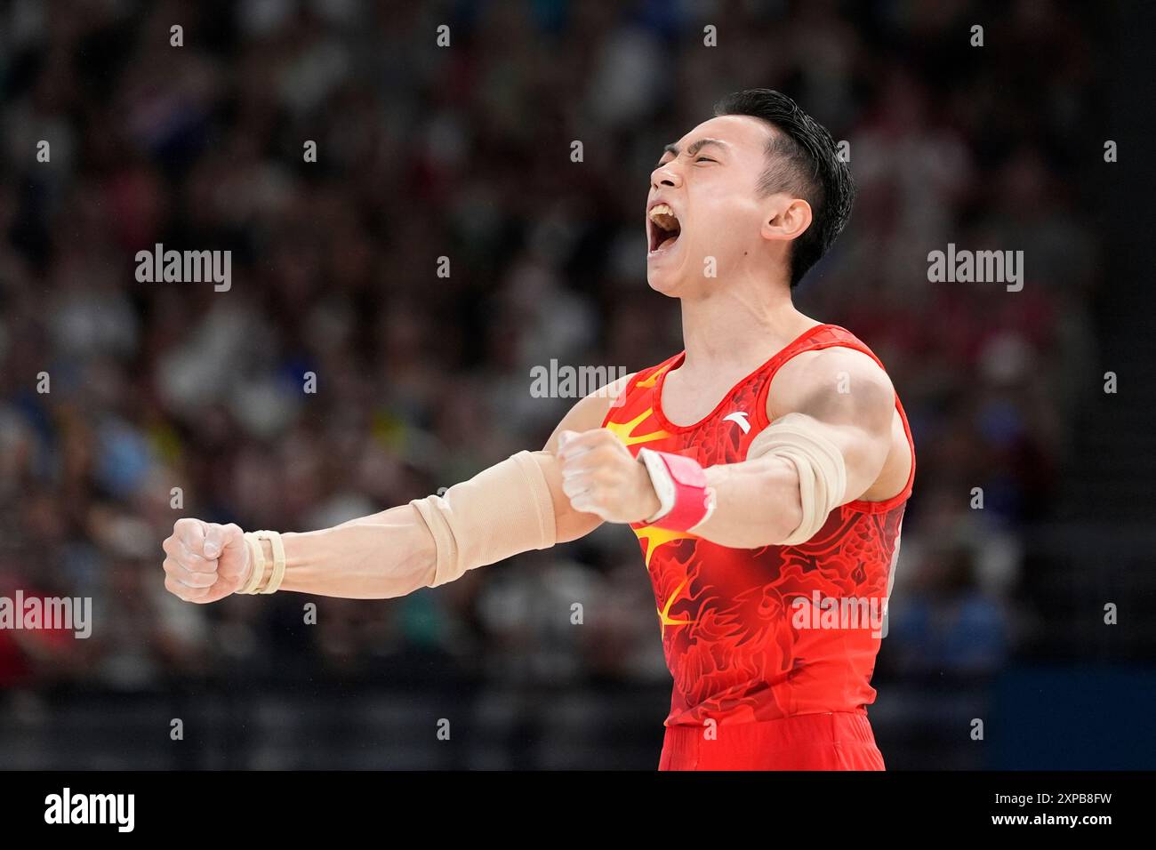 Zou Jingyuan, of China, celebrates after completing his routine in the ...
