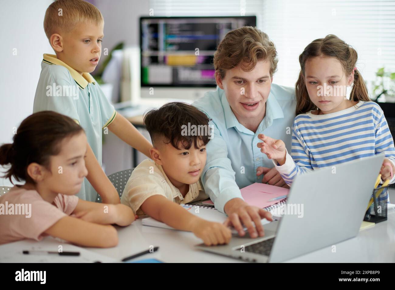 Group of Children and Teacher Collaborating on Lesson Stock Photo - Alamy