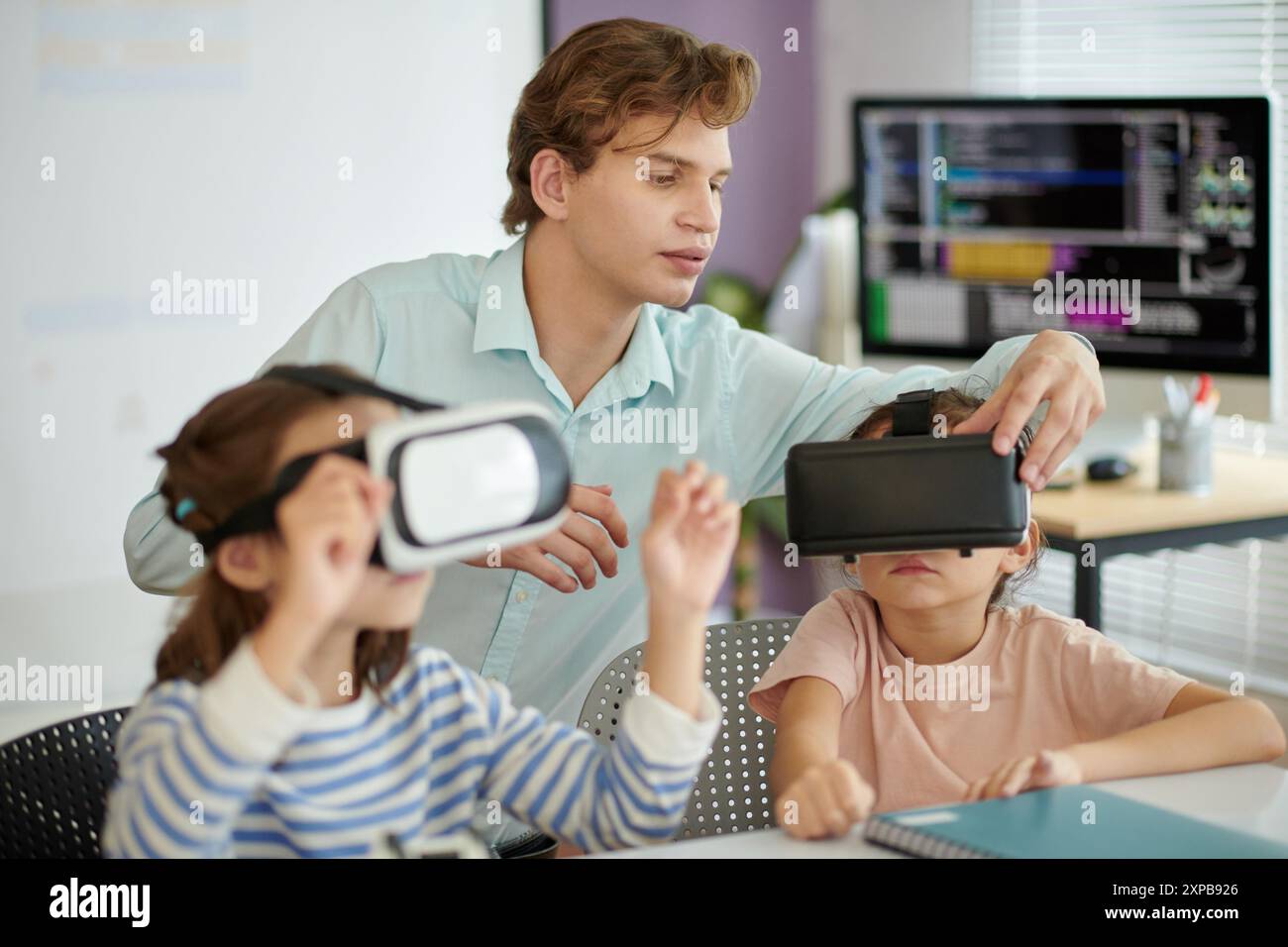 Guiding Children in Using Virtual Reality Technology Stock Photo - Alamy