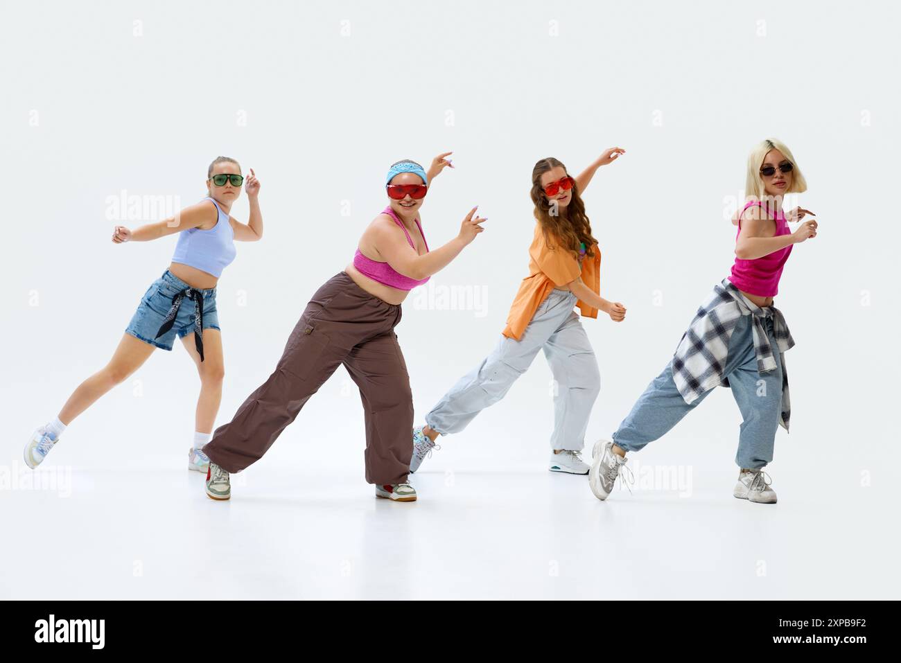 Young girls, dancers strike dynamic pose in colorful outfits and ...