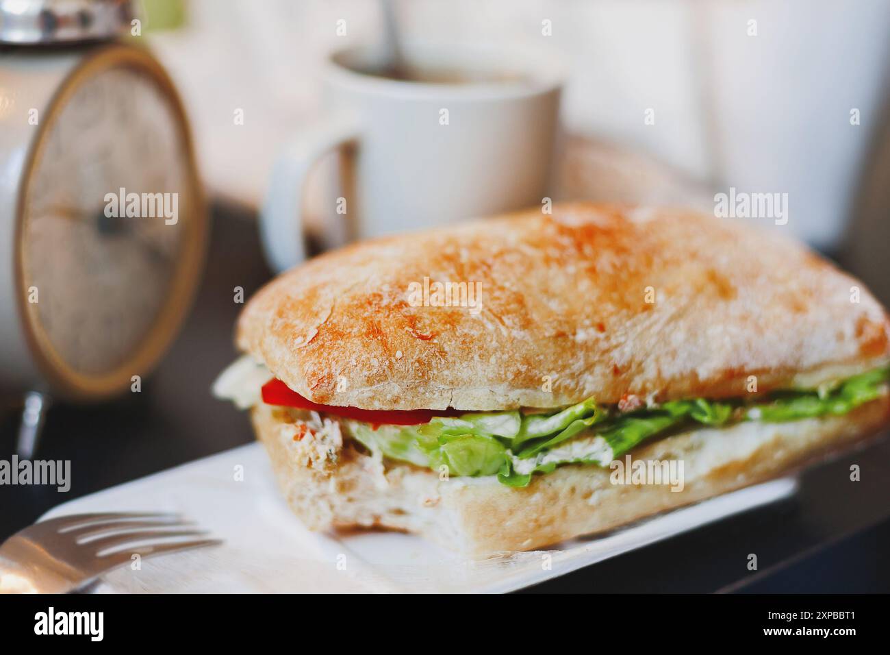 Time for lunch with big tasty sandwich and cup of coffee. Hamburger and ...