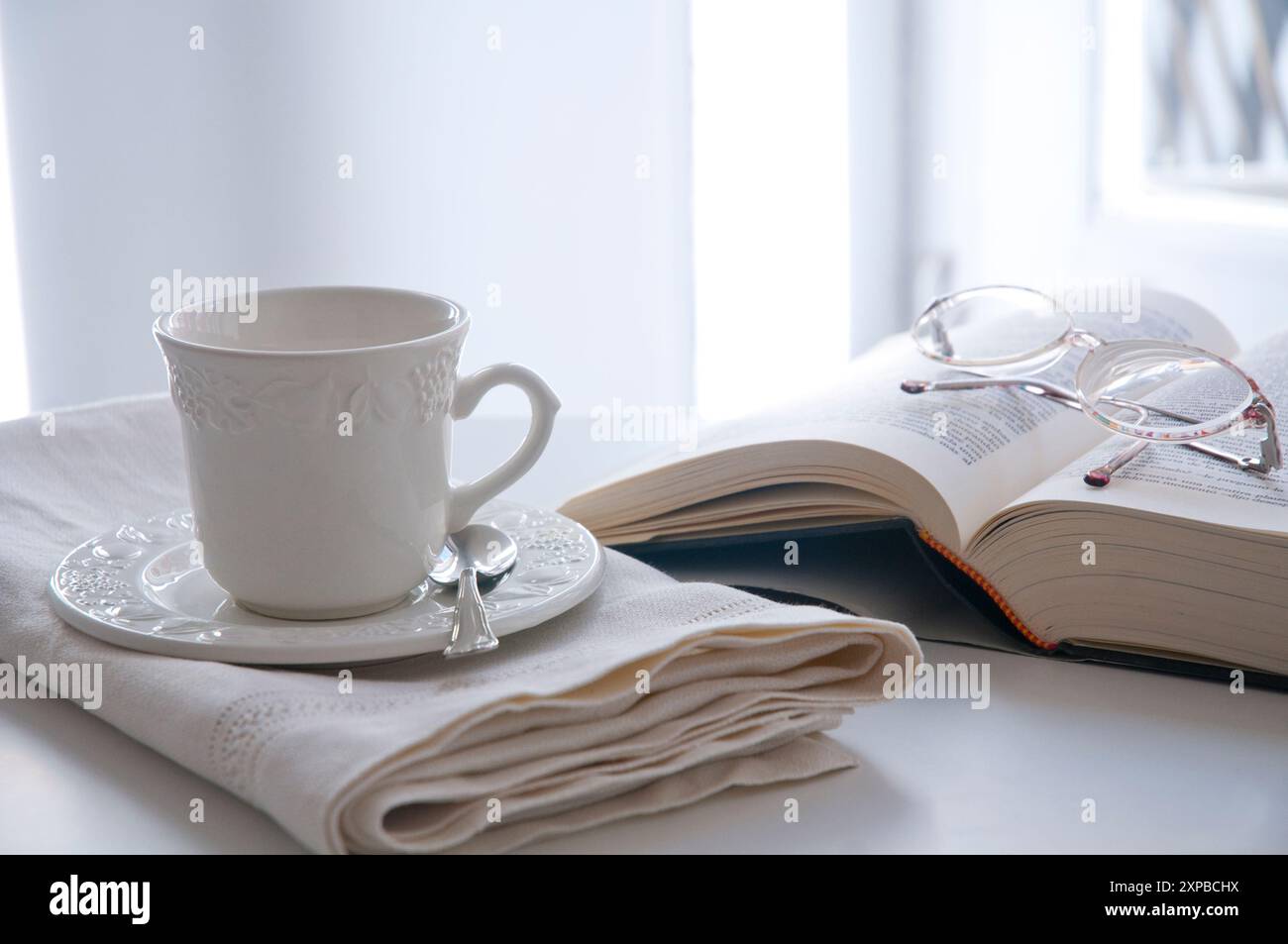 Cup, book and eyeglasses Stock Photo - Alamy