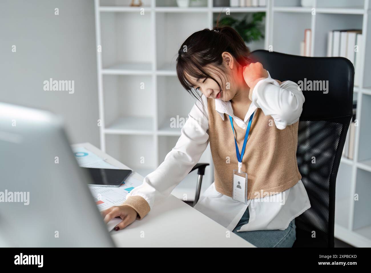 Young Woman Experiencing Neck Pain While Working at Desk in Modern ...