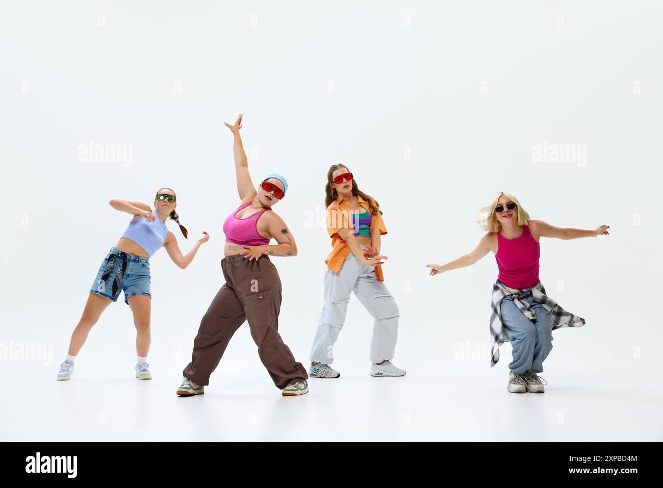 Girls dancing, dressed streetwear, with fun, energetic expression ...