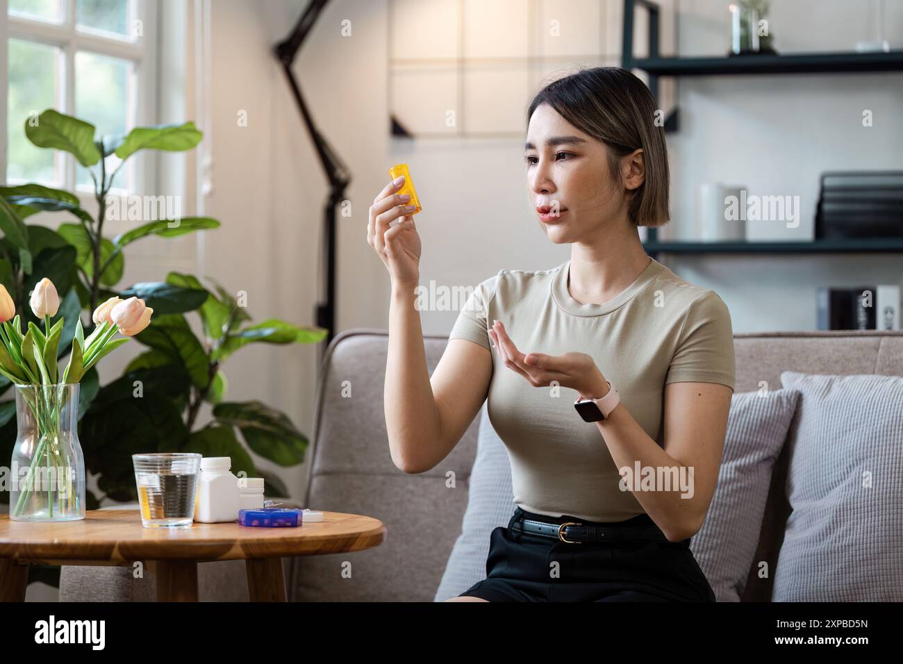 Young Woman Taking Medication at Home - Healthcare and Wellness Concept ...
