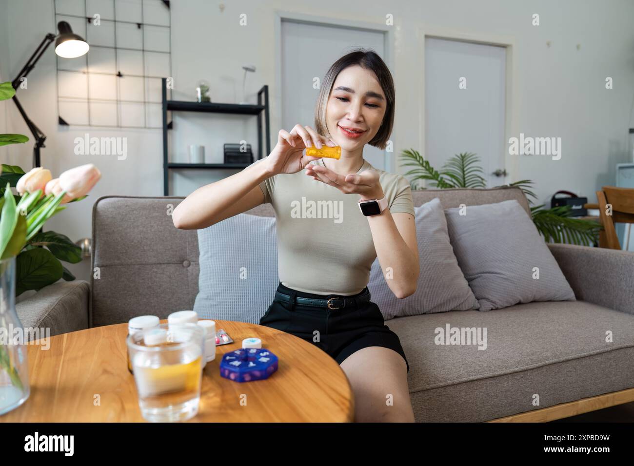Young Woman Taking Medication at Home - Healthcare and Wellness Concept ...
