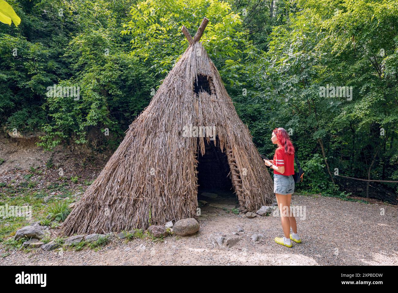 09 June 2024, Boljetin, Serbia: Visitor exploring ancient huts and ...